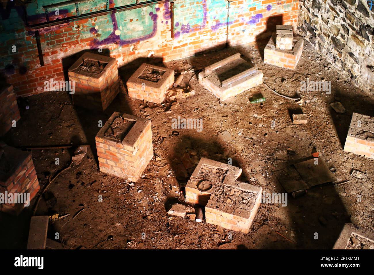 Brickwork bases for several industrial devices in an abandoned factory ...