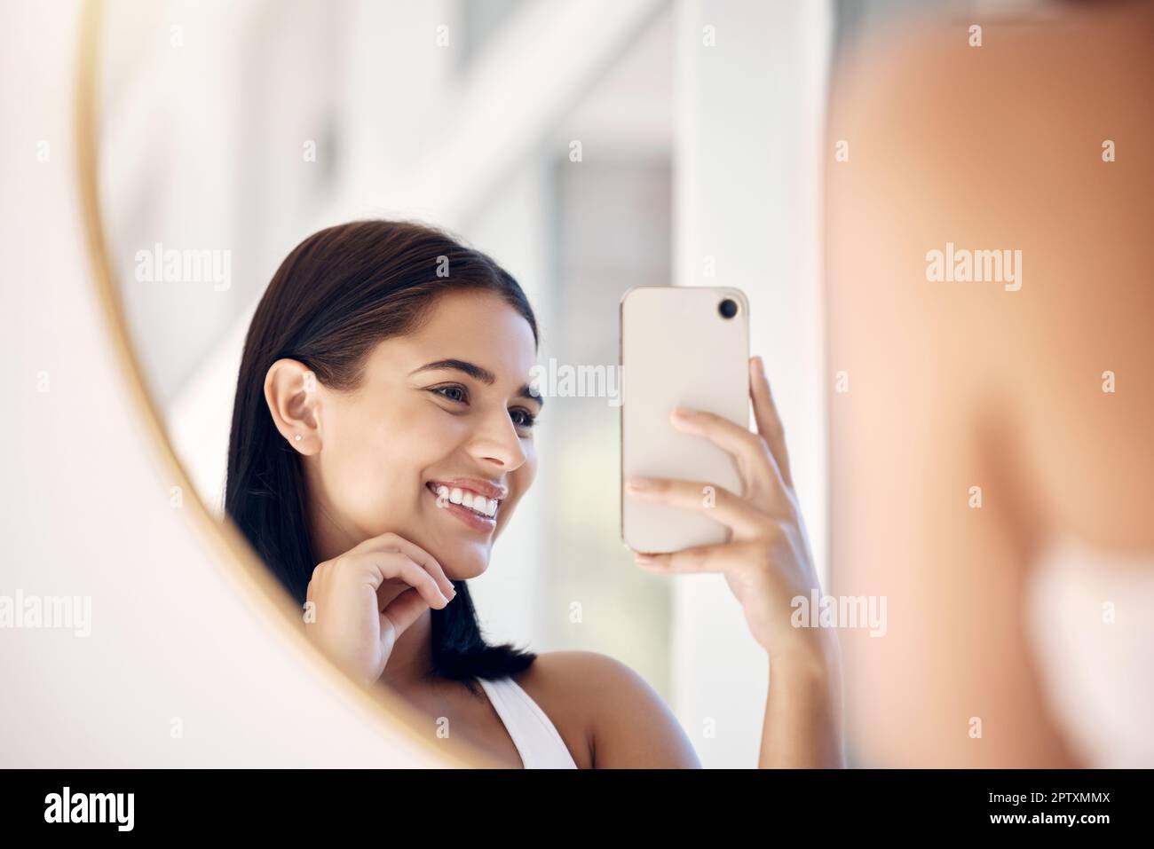 Phone, happy and selfie of woman in bathroom with smile for natural social media beauty in ...