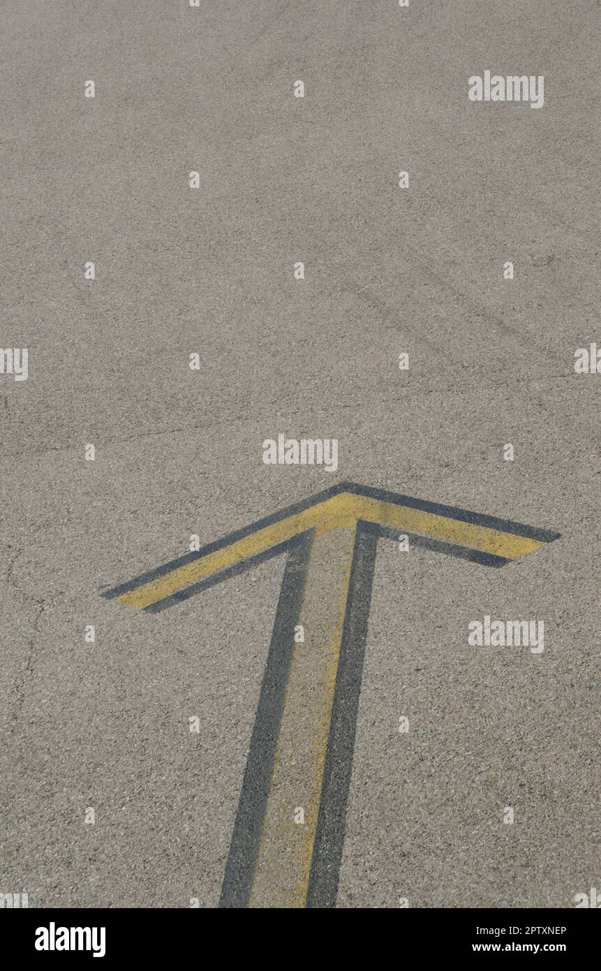 Arrow on the runway of the Adolfo Suarez Madrid-Barajas Airport. Madrid ...