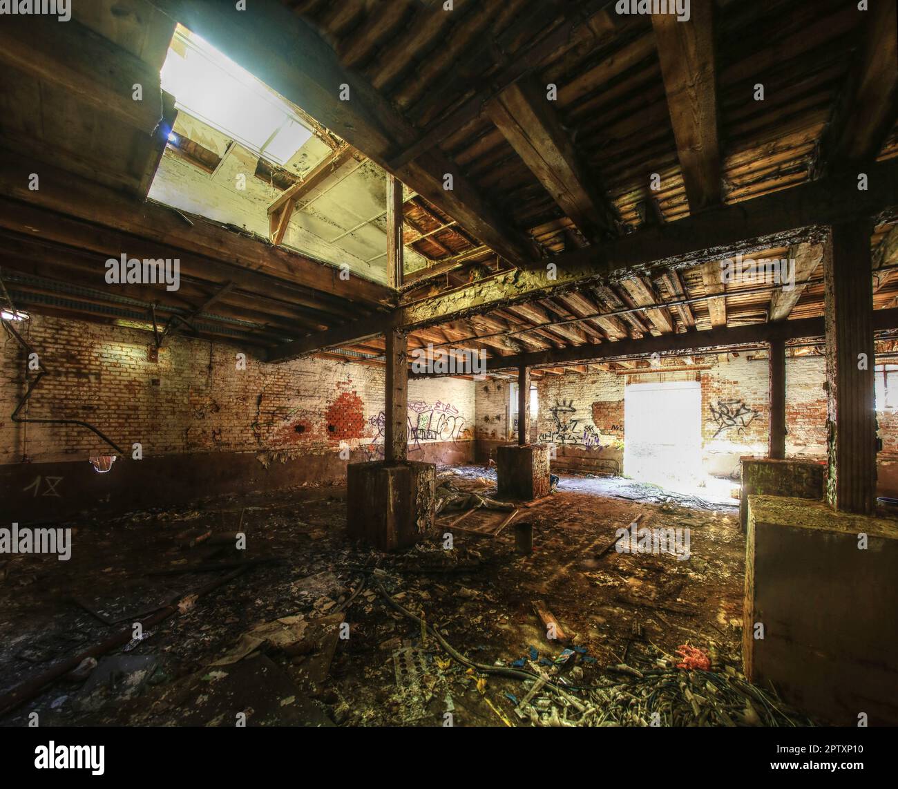Interior of an abandoned storage building with bright daylight coming ...