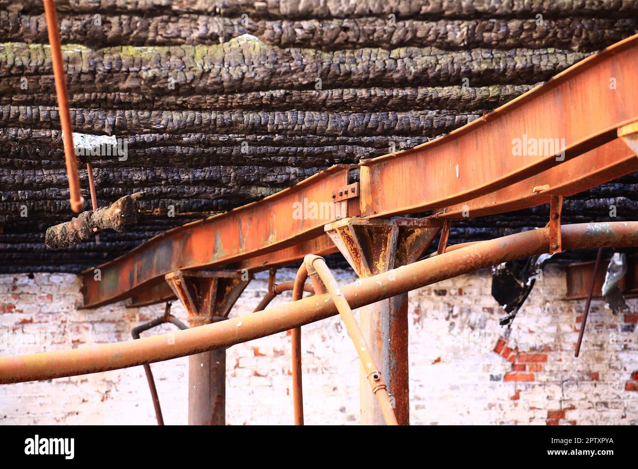 Burnt wooden beams and warped steel girders in a ruin Stock Photo - Alamy