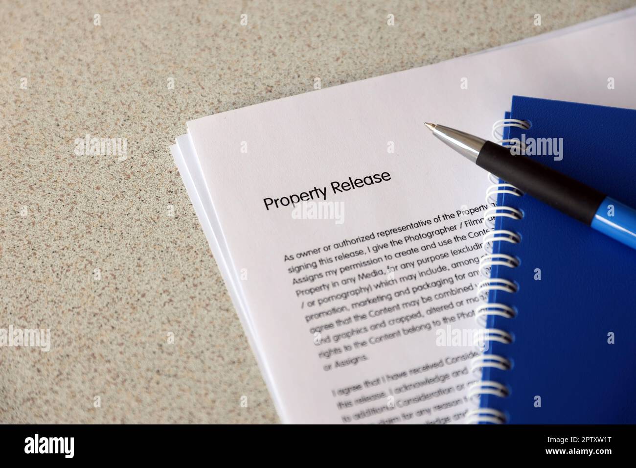 Property release blank form with blue notepad and blue pen lies on ...