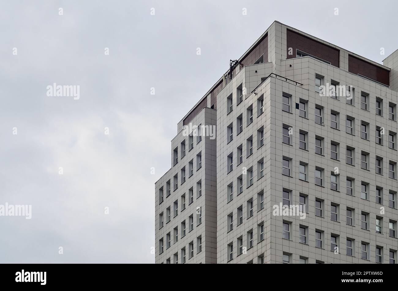 Multi-story office building beige color with lots of glass windows on a ...