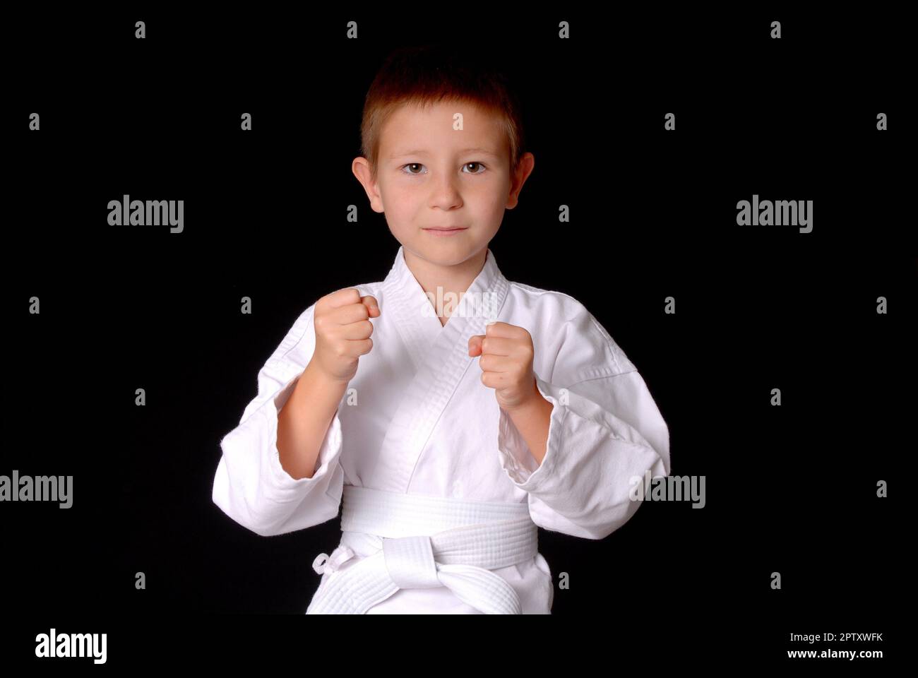 Young boy in karate outfit making fighting movement Stock Photo - Alamy