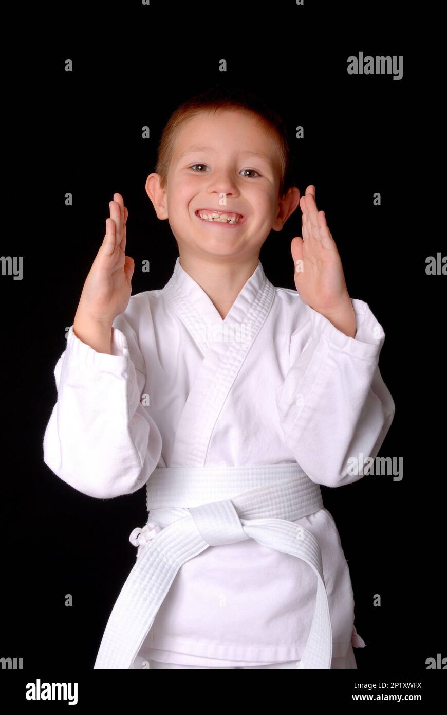 Young boy in karate outfit making fighting movement Stock Photo - Alamy