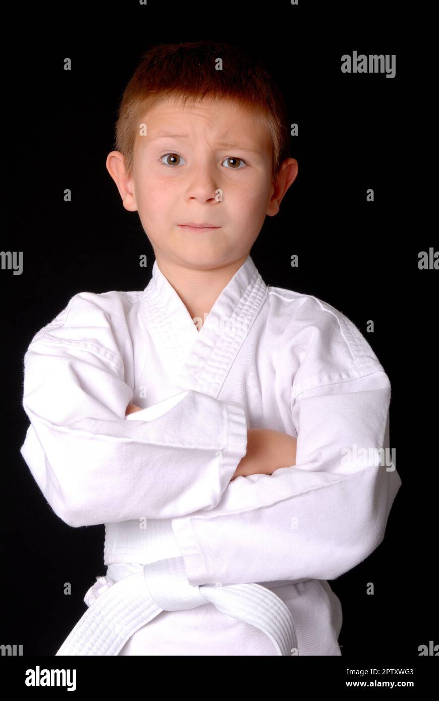 Young boy in karate outfit making fighting movement Stock Photo - Alamy