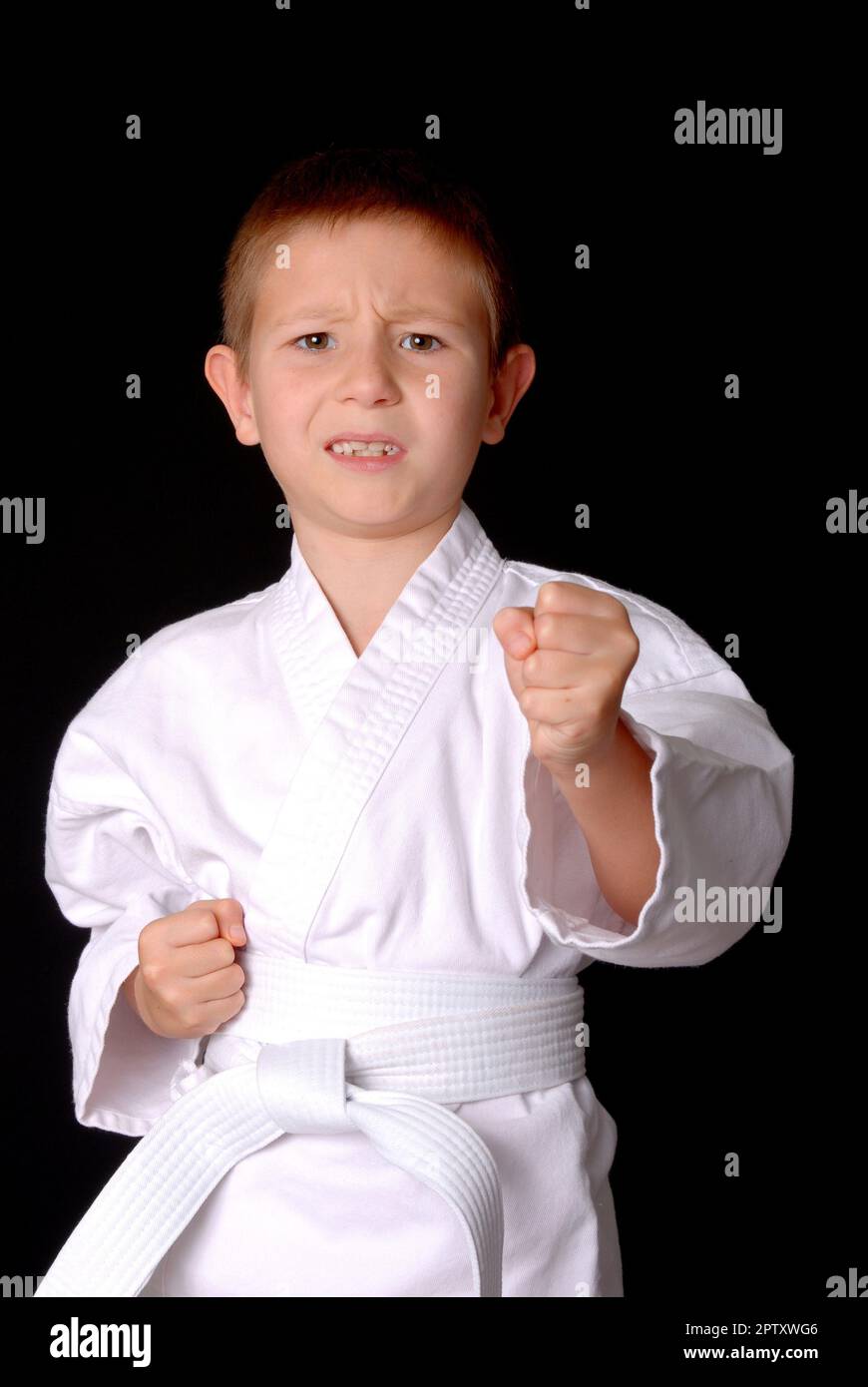 Young boy in karate outfit making fighting movement Stock Photo - Alamy