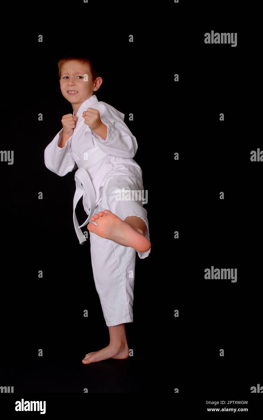 Young boy in karate outfit making fighting movement Stock Photo - Alamy
