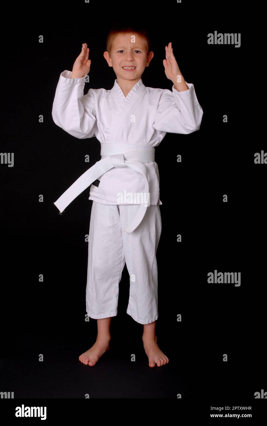 Young boy in karate outfit making fighting movement Stock Photo - Alamy