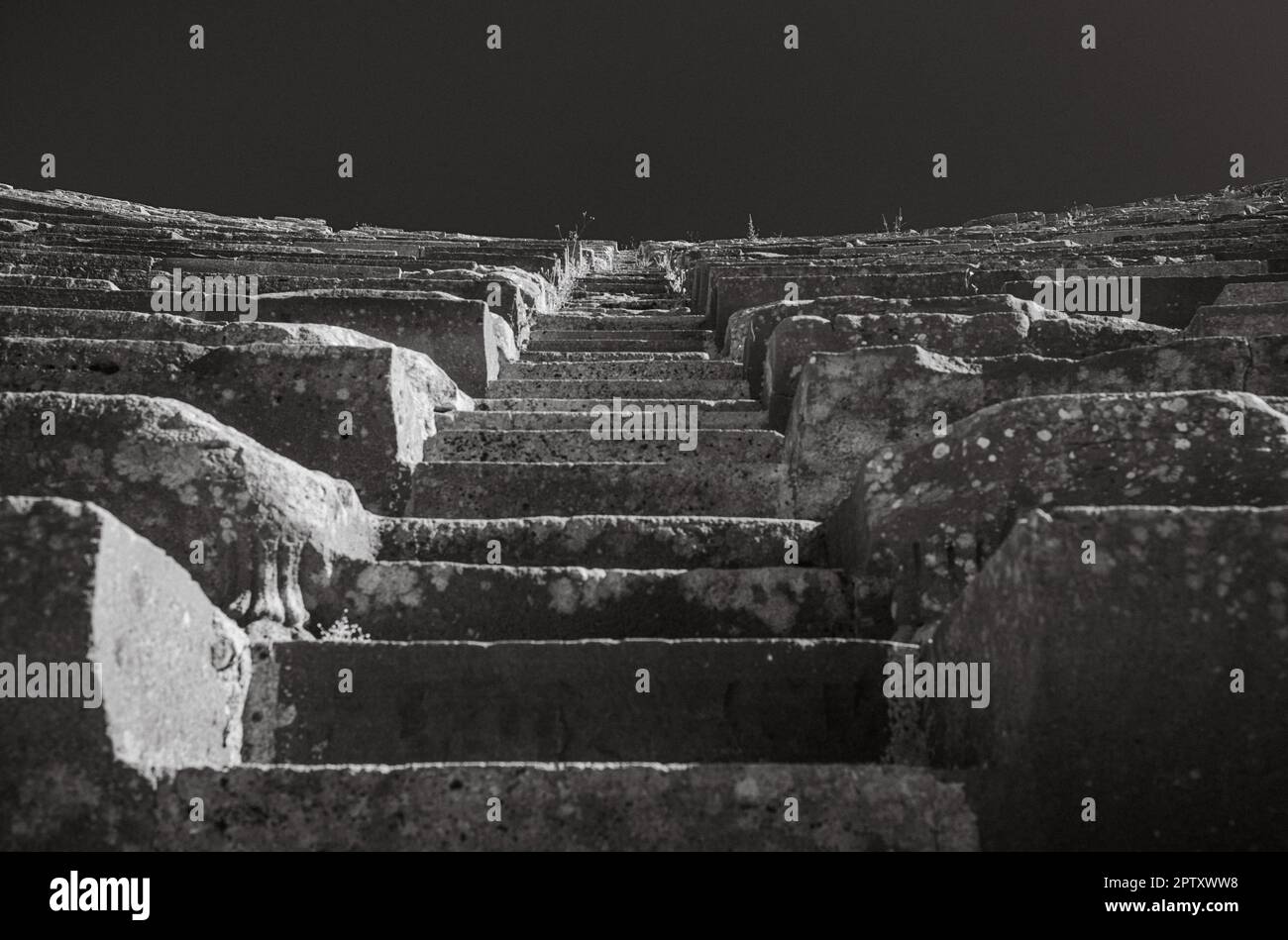 Looking up steep steps past rows of stone bench seating at the ...