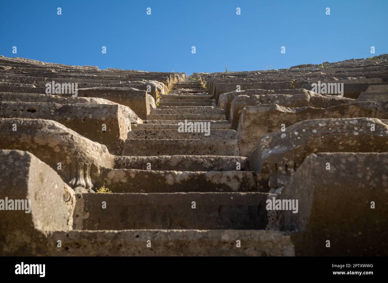 Looking up steep steps past rows of stone bench seating at the ...