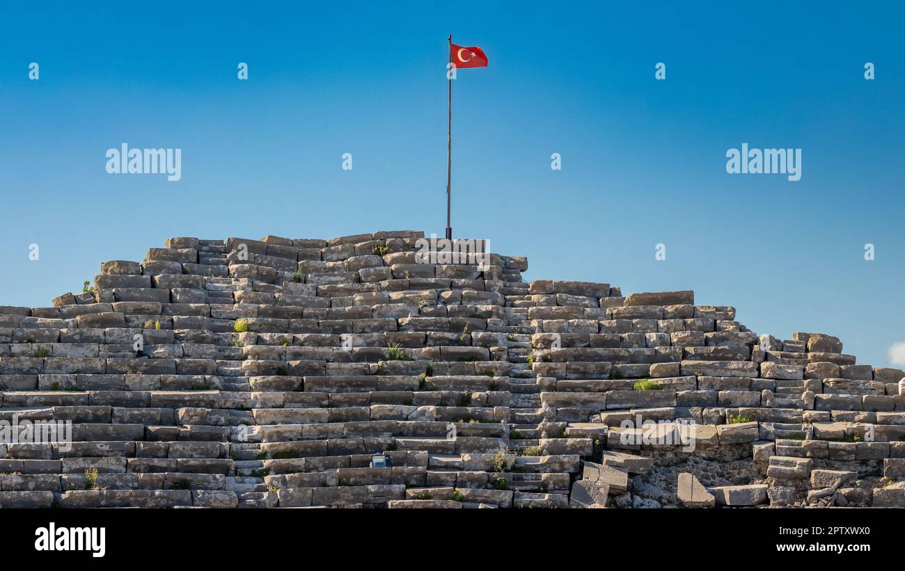 A Turkish flag flies atop the grand Roman amphitheatre at Side in ...