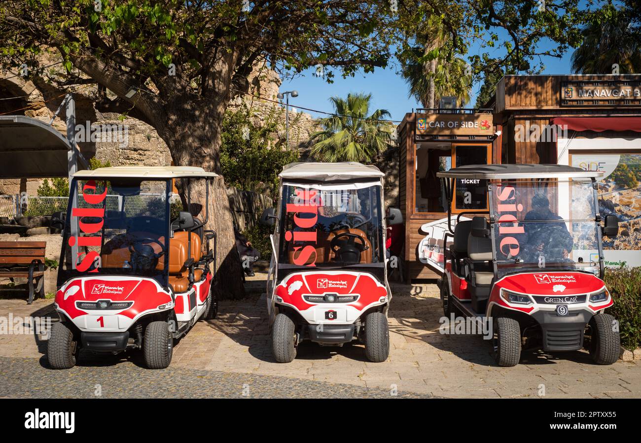 Three electric buggy golf carts lined up waiting for tourists to ...