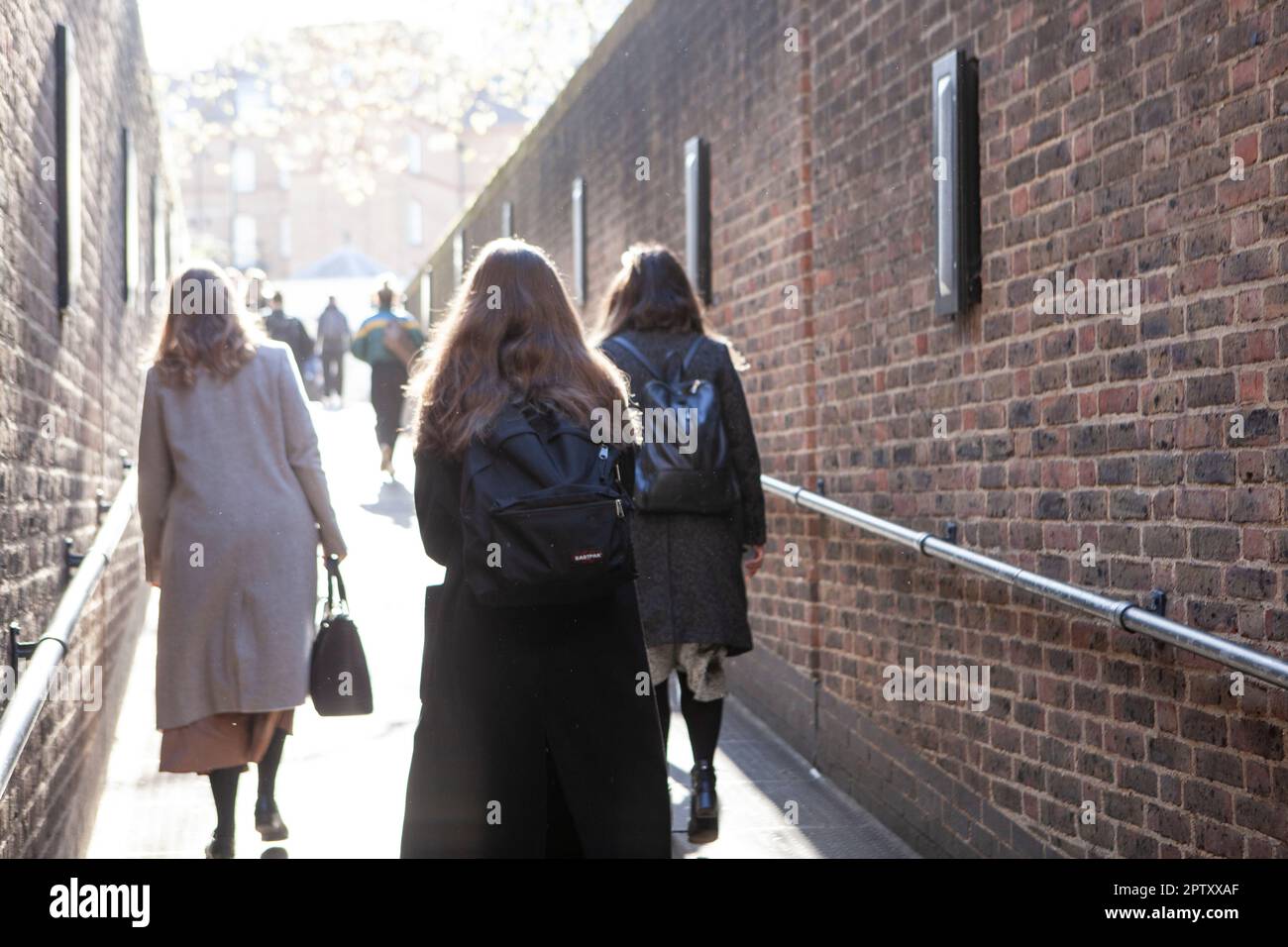 London, UK, 25 April 2023: At Pimlico tube station three women walk up ...