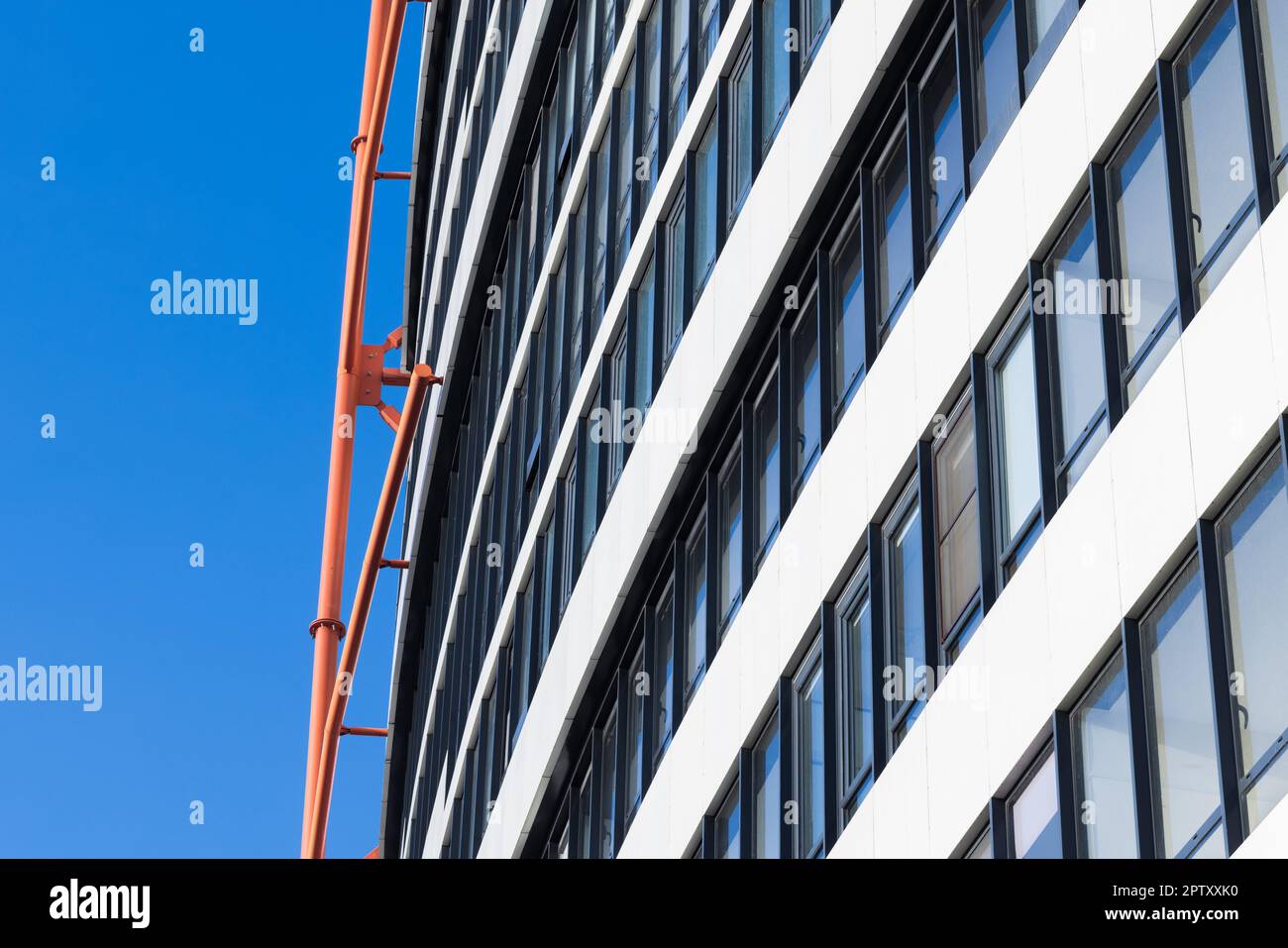 Abstract modern architecture background, white house facade with red steel constructions is ...
