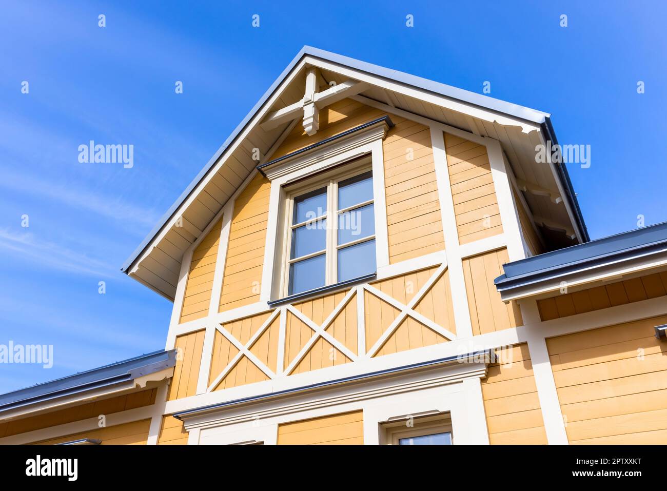 New wooden country house exterior fragment, yellow gable with white ...