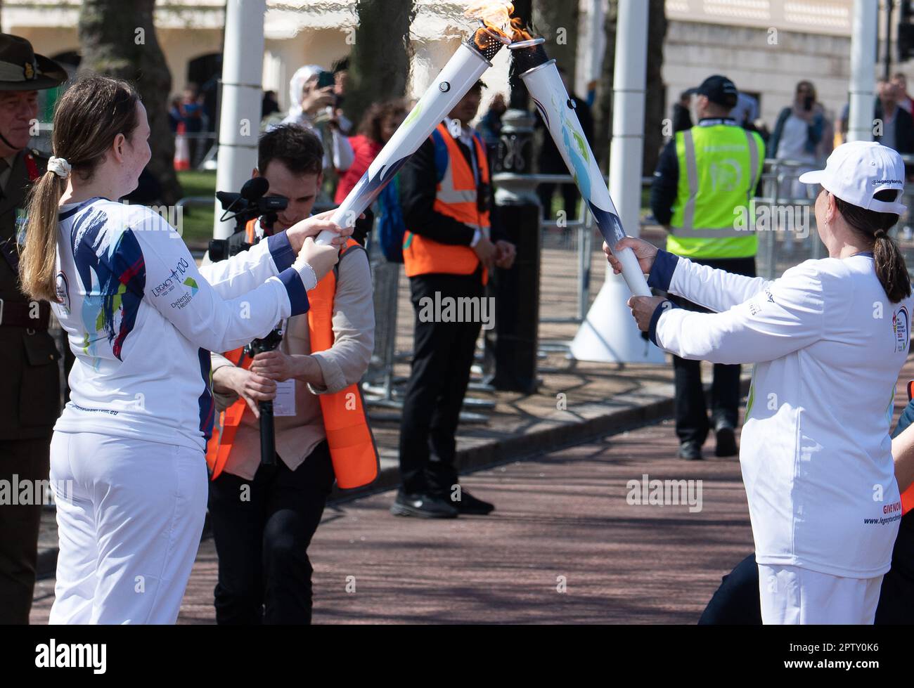 London, UK. 28th April, 2023. Torch bearers accompanies by military ...
