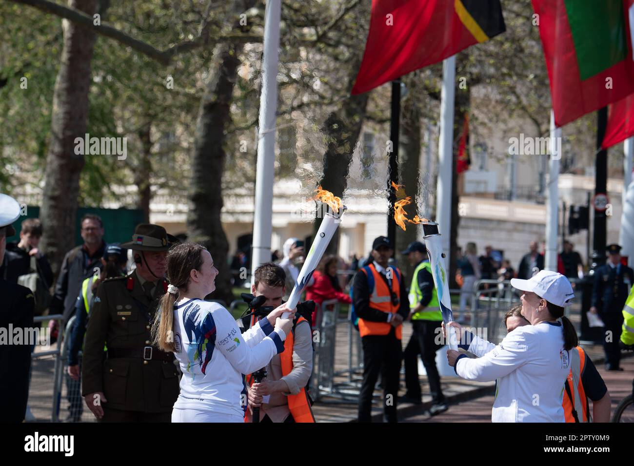 London, UK. 28th April, 2023. Torch bearers accompanies by military ...