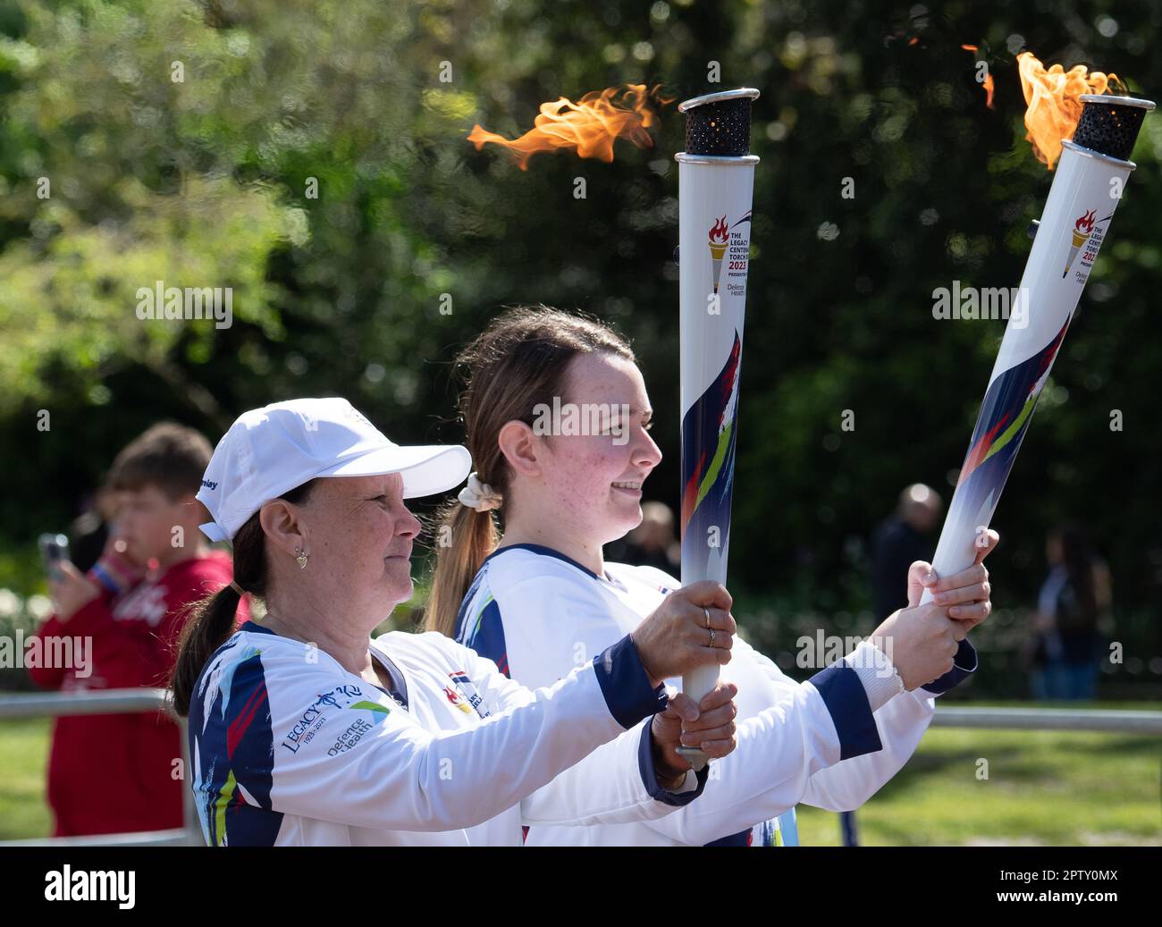 London, UK. 28th April, 2023. Torch bearers accompanies by military ...