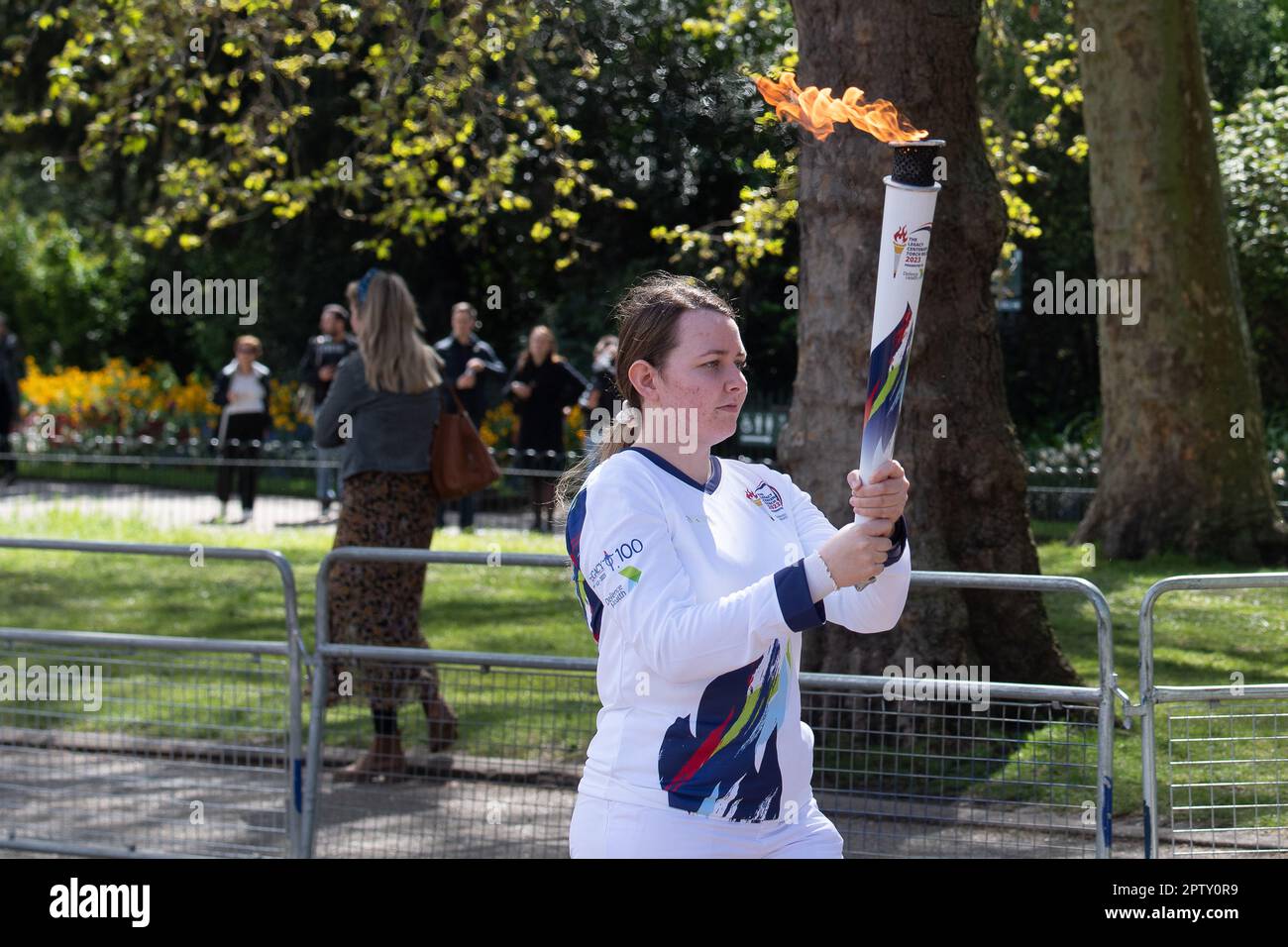 London, UK. 28th April, 2023. Torch bearers accompanies by military ...