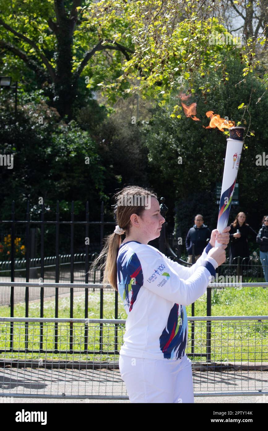 London, UK. 28th April, 2023. Torch bearers accompanies by military ...