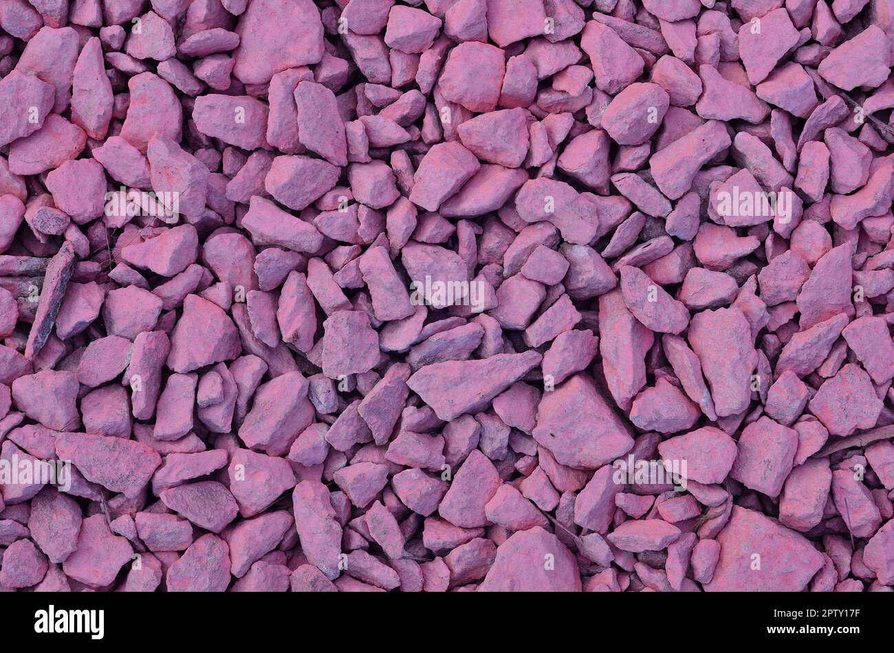 Texture from a pile of crushed stone, painted in light pink color ...