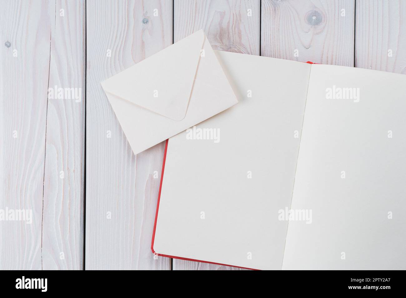 Red diary book with white paper with handmade, craft envelope on light ...