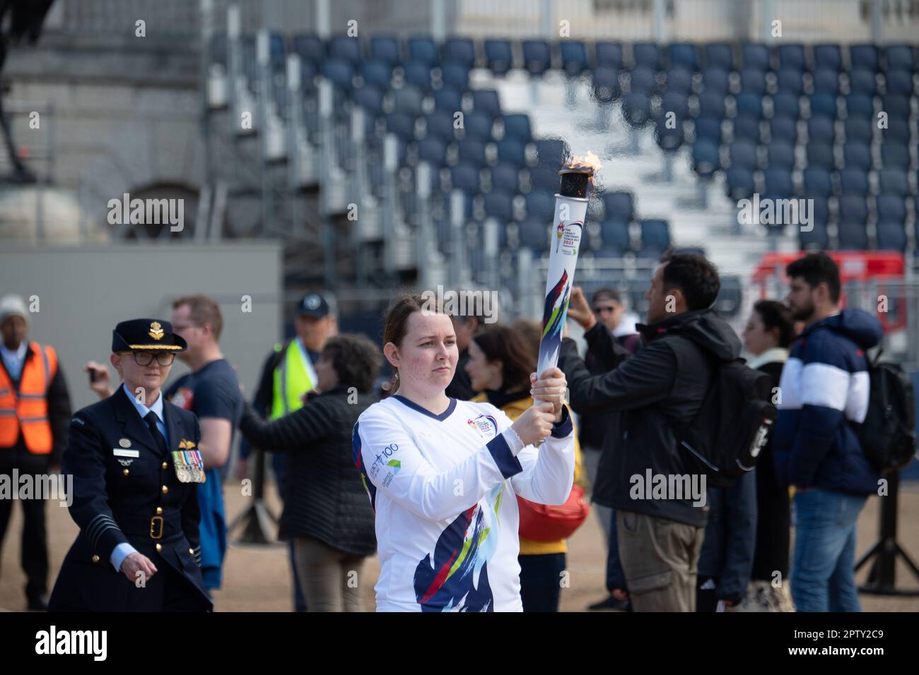 London, UK. 28th April, 2023. Torch bearers accompanies by military ...