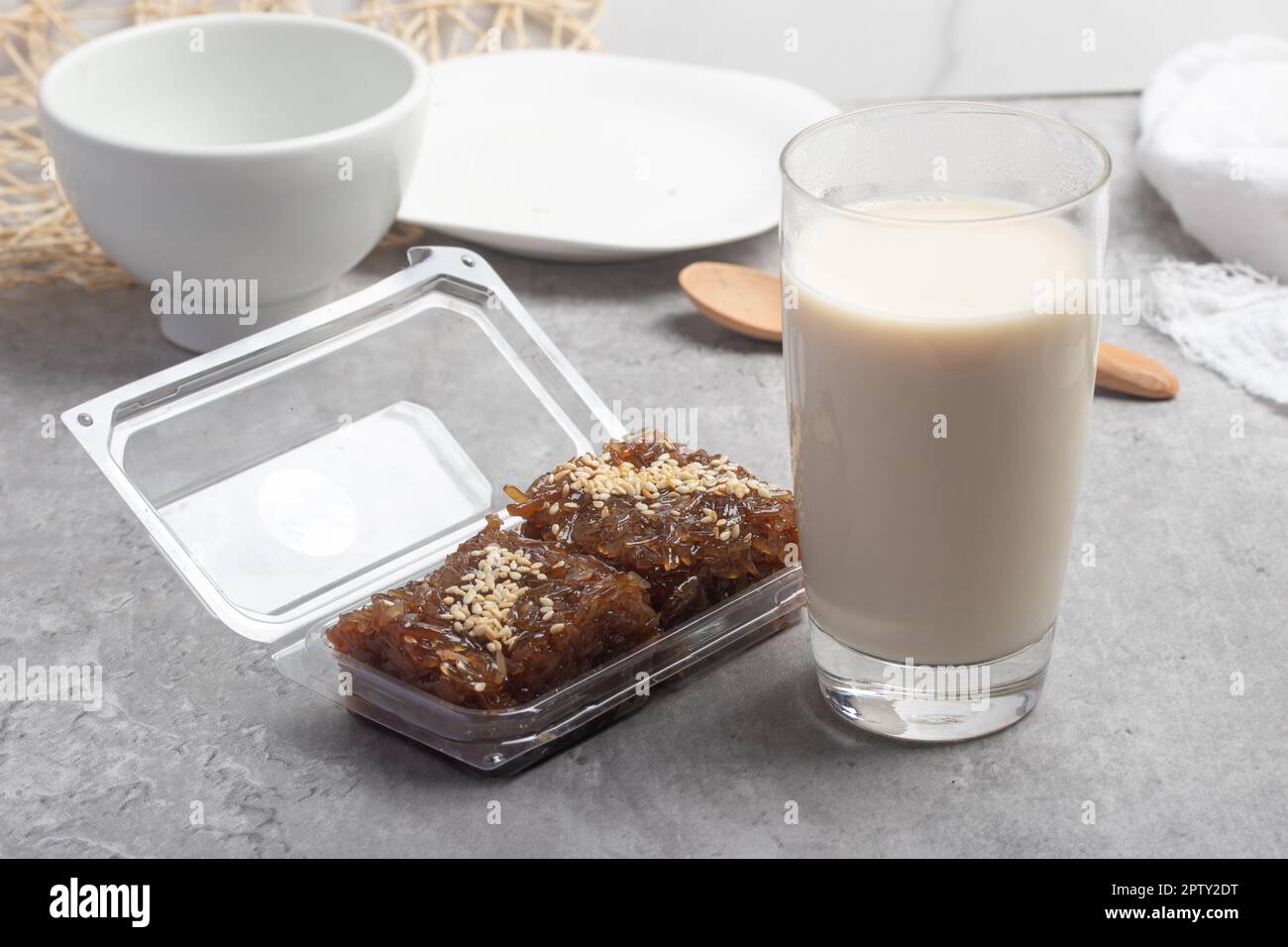 Hot fresh milk in transparent glass on gray background Stock Photo - Alamy