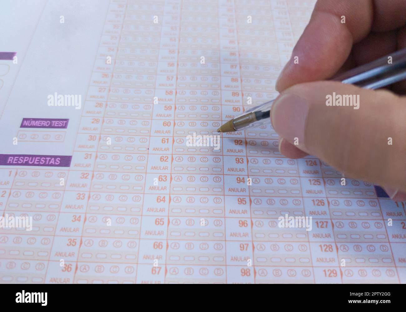 Candidate hand holds a ballpen over multiple-choice test. Public ...