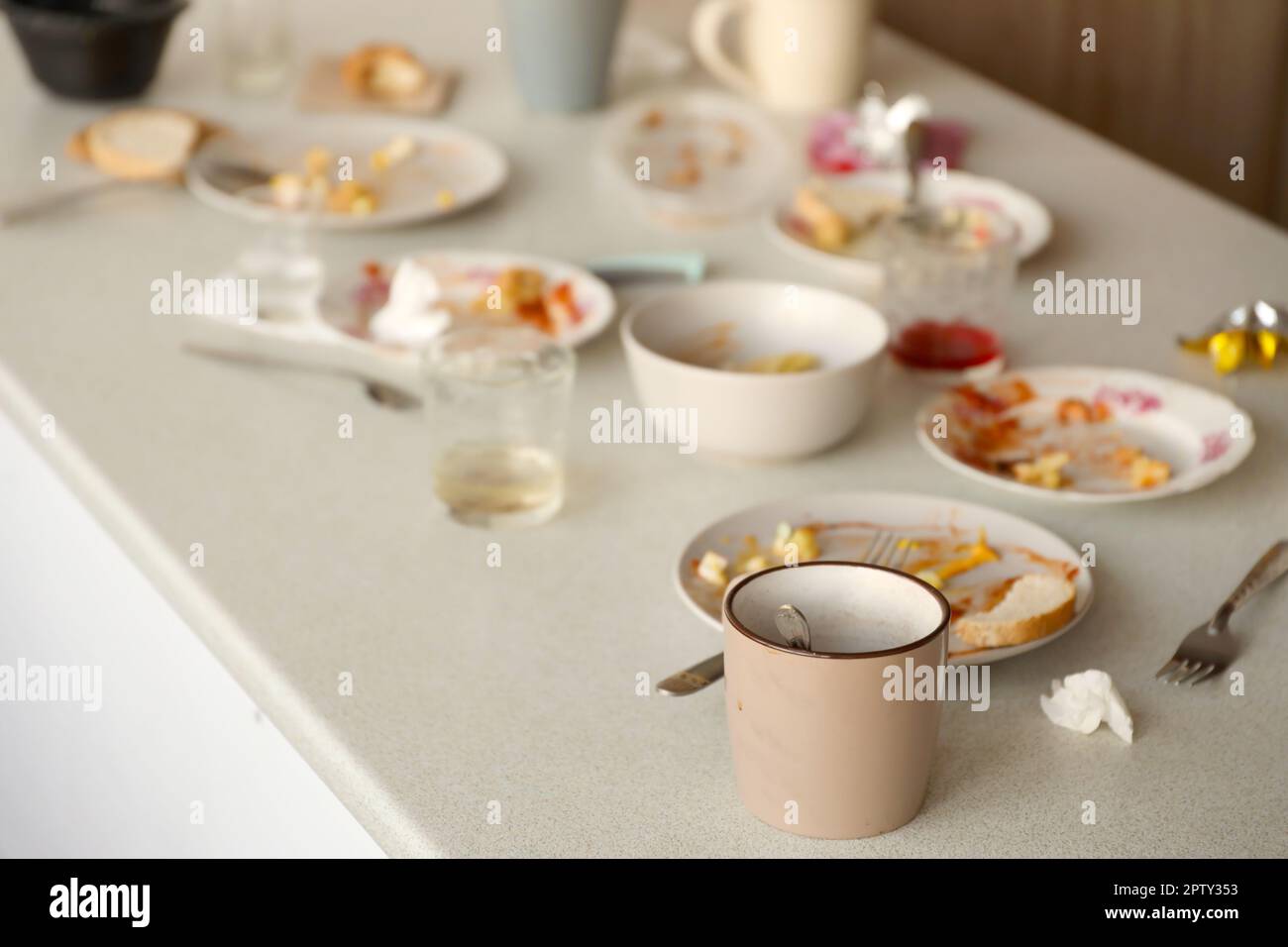 Empty dirty plates with spoons and forks on the table after meal ...