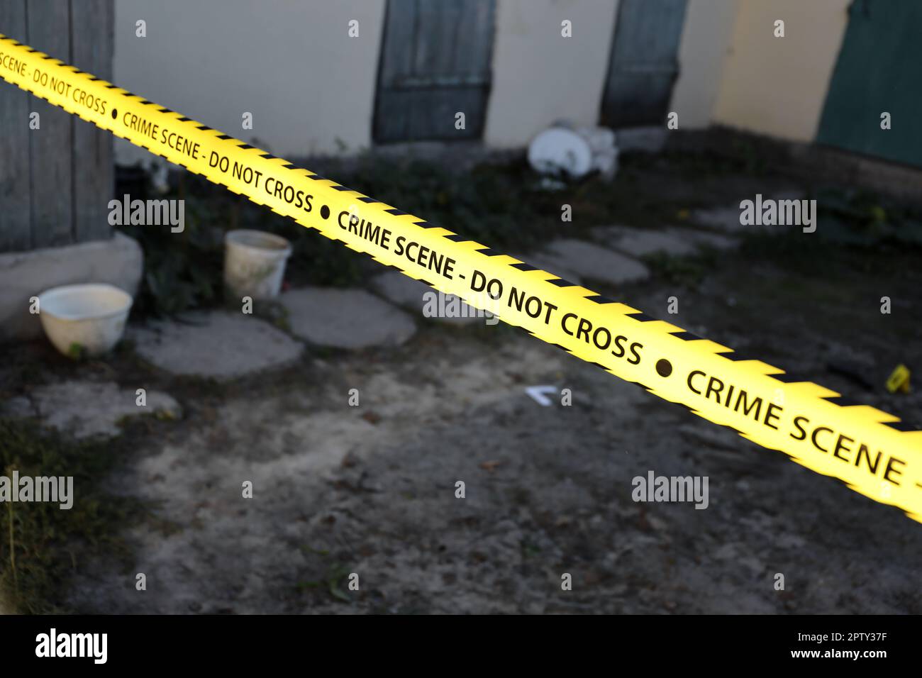 Crime scene tape for covering the area cordon. Yellow tape with blurred ...