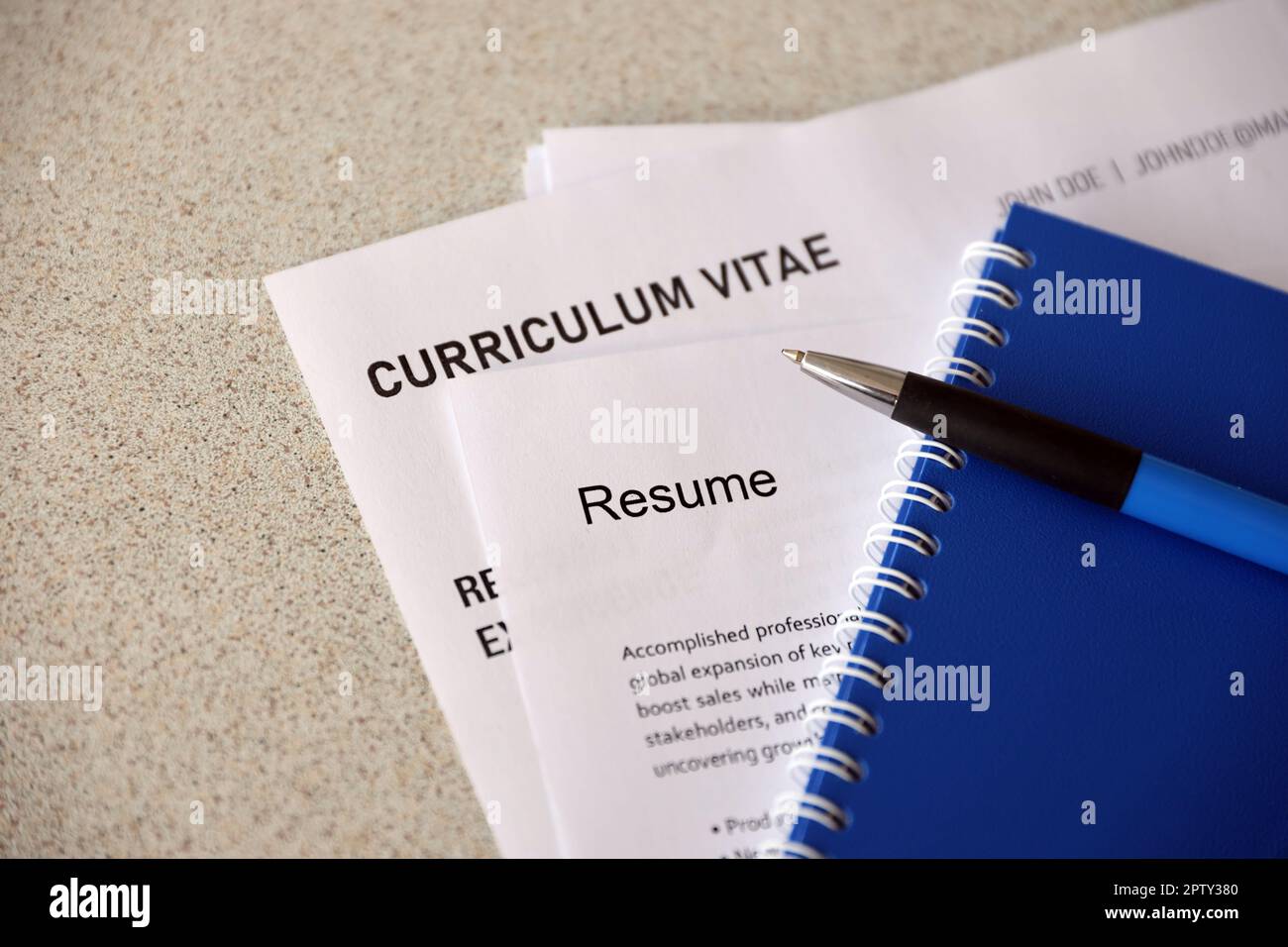 Top view of stack of office documents including resume and cv forms on ...