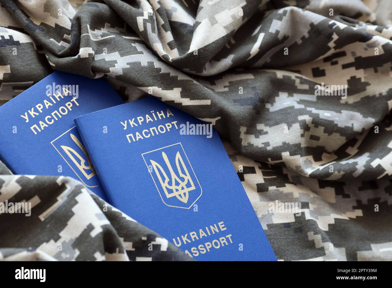 Ukrainian foreign passport on fabric with texture of military pixeled ...
