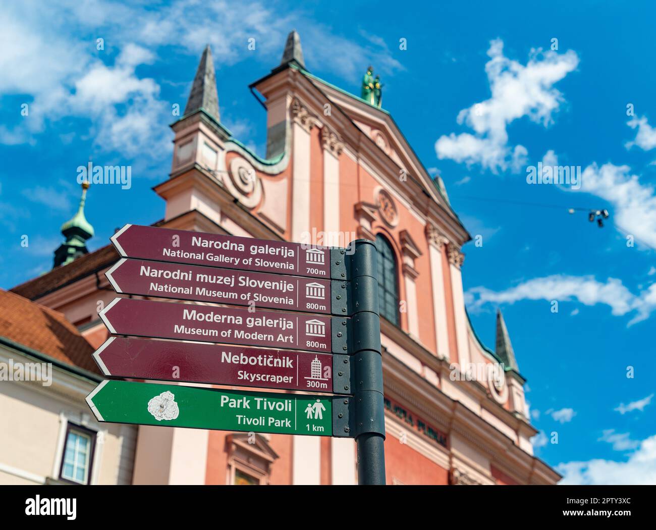 A picture of street signs in front of the Franciscan Church of the ...