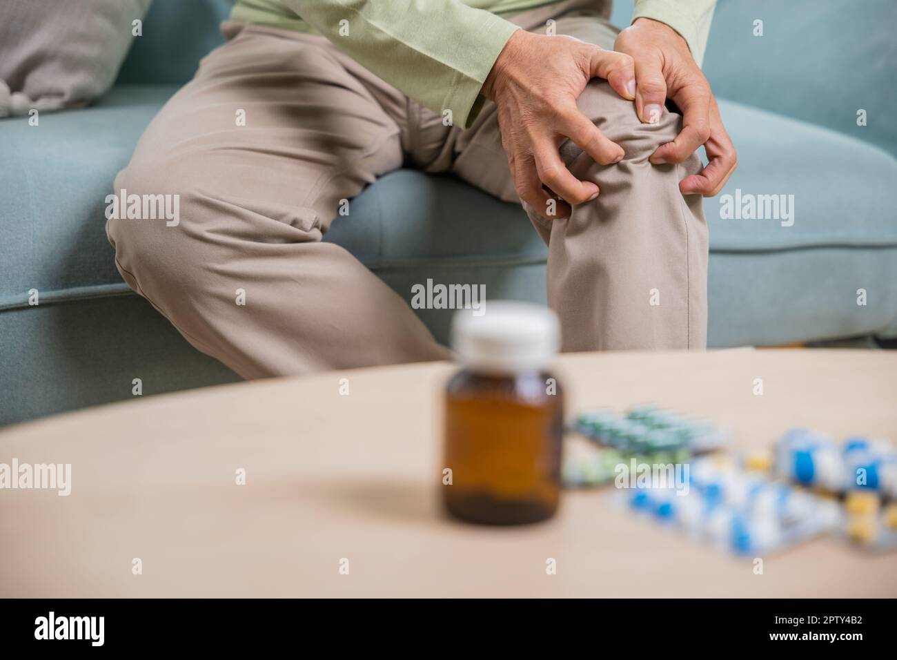 Old age. Asian senior man retirement knee joint pain on sofa, Elderly ...