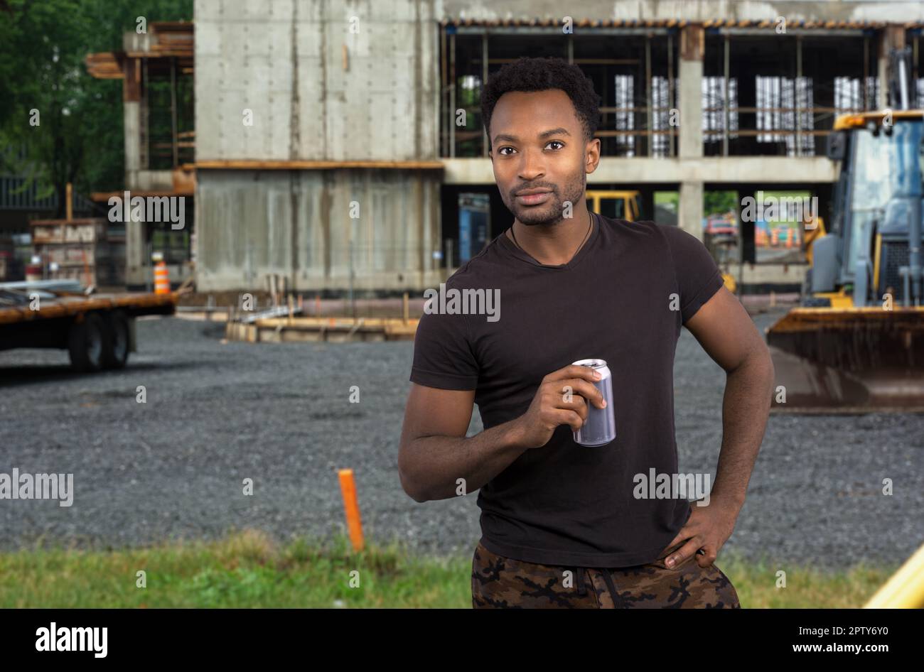 worker on break drinking soda at construction site job break tired man ...