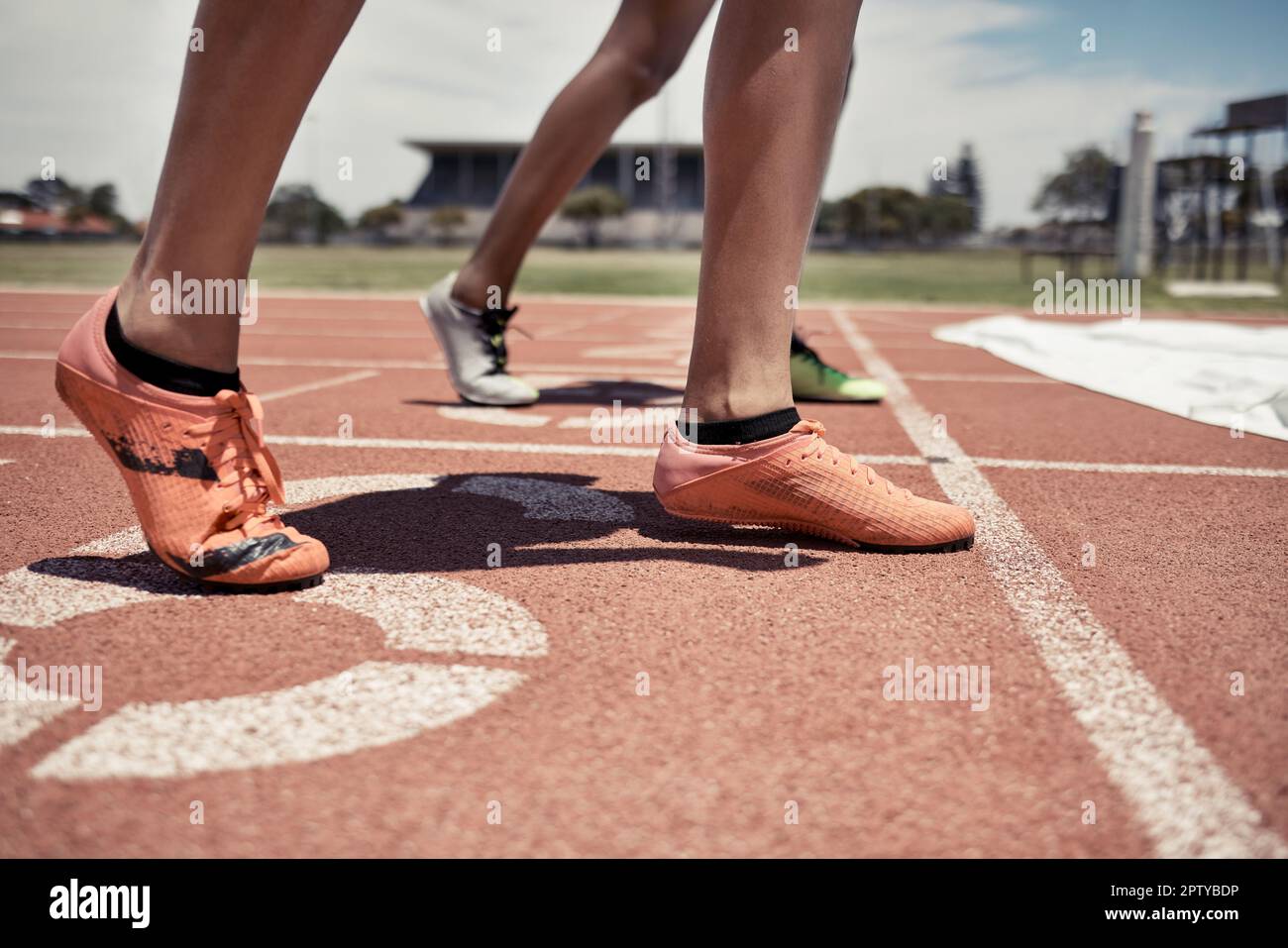 Feet, athlete and sports race at stadium for marathon or sprint ...