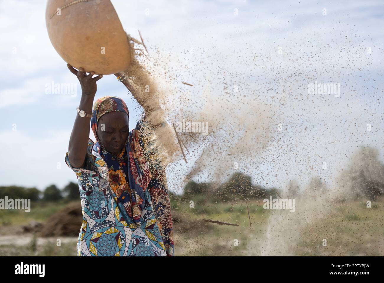 African woman winnowing millet hi-res stock photography and images - Alamy