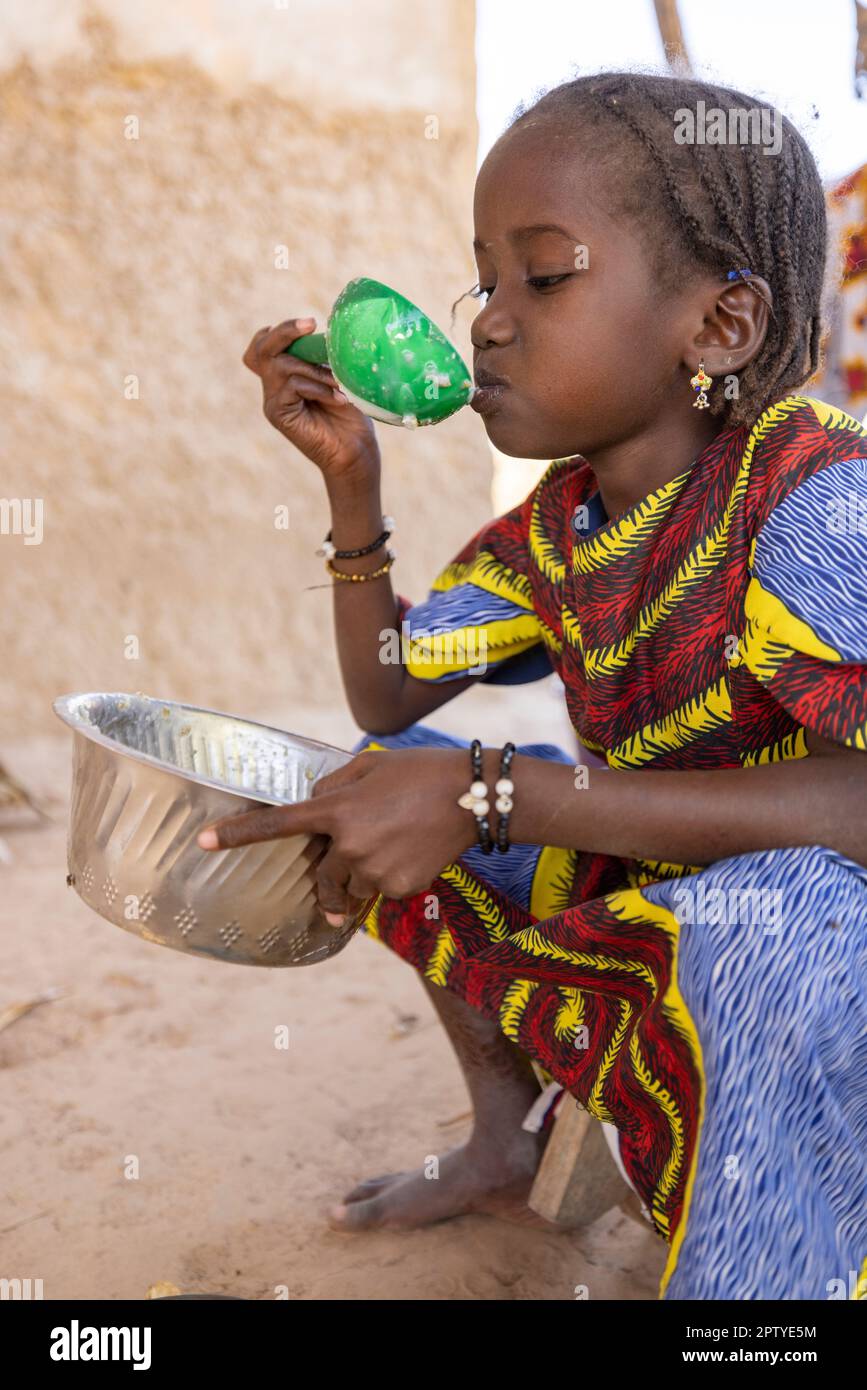Fulani IDP girl eating morning porridge in Segou Region, Mali, West ...