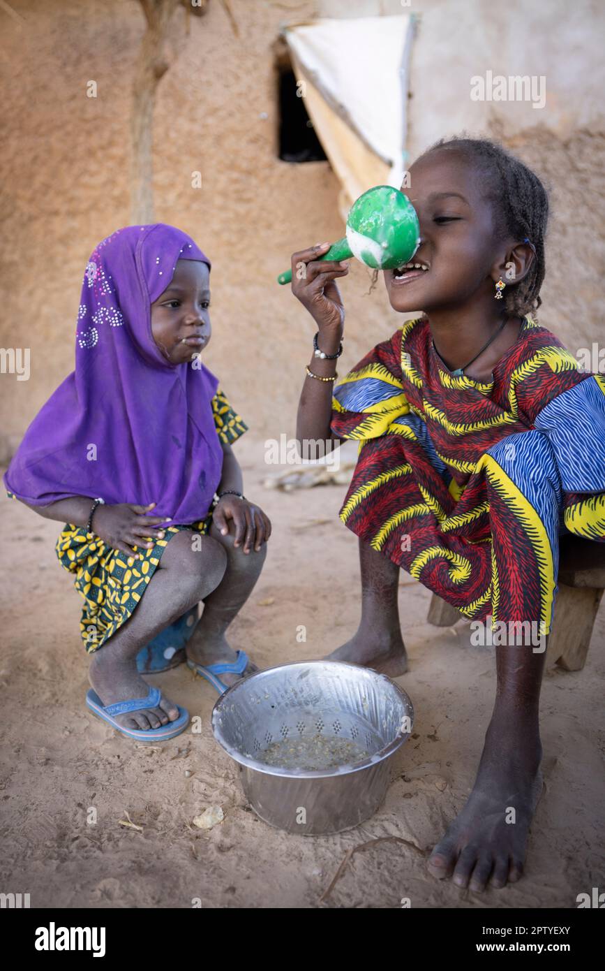 Fulani IDP girl eating morning porridge in Segou Region, Mali, West ...