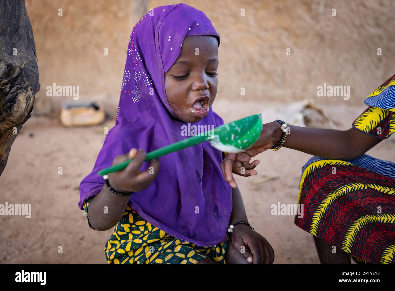 Fulani IDP girl eating morning porridge in Segou Region, Mali, West ...