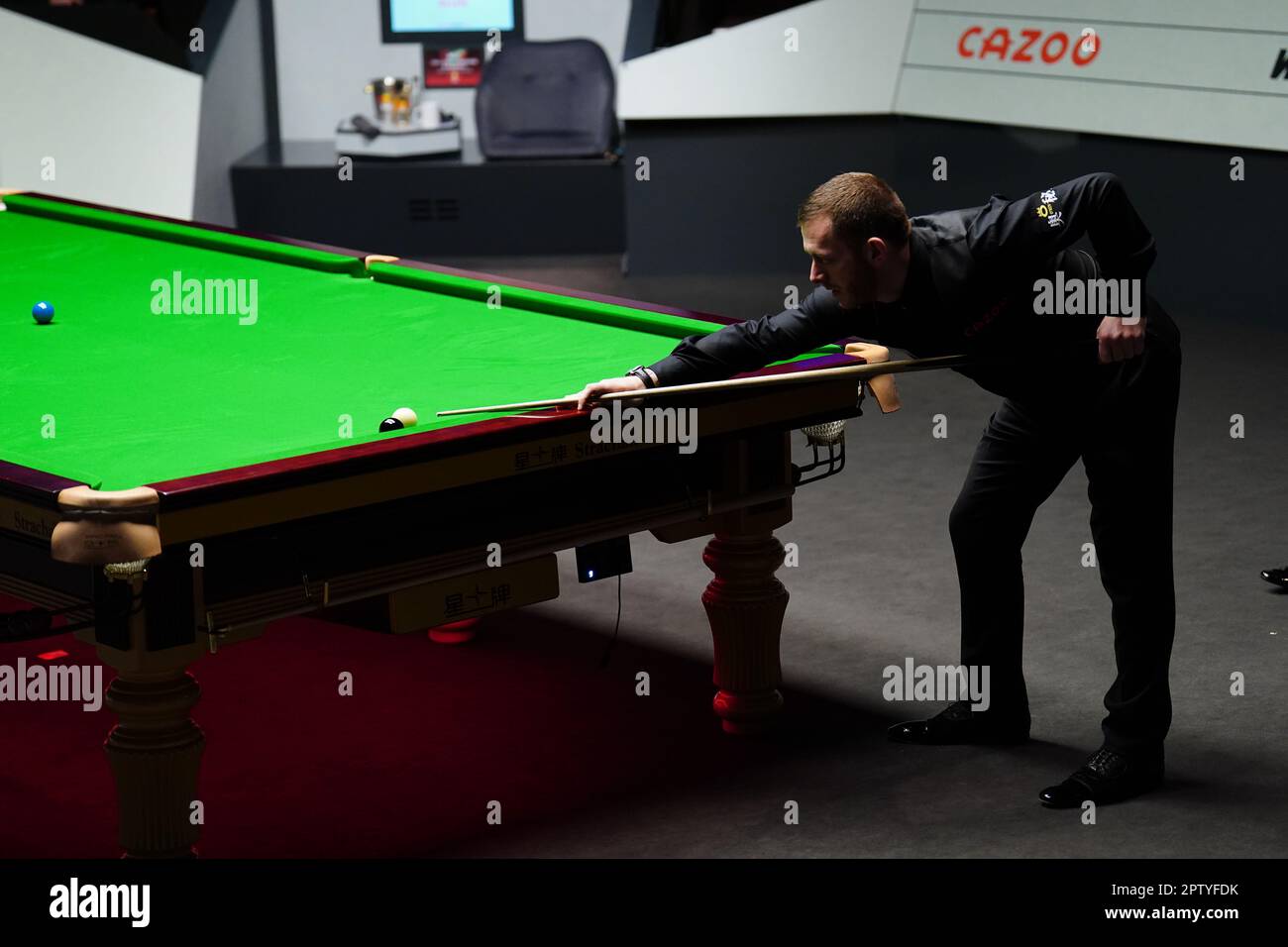 Mark Allen in action against Mark Selby (not pictured) on day fourteen ...