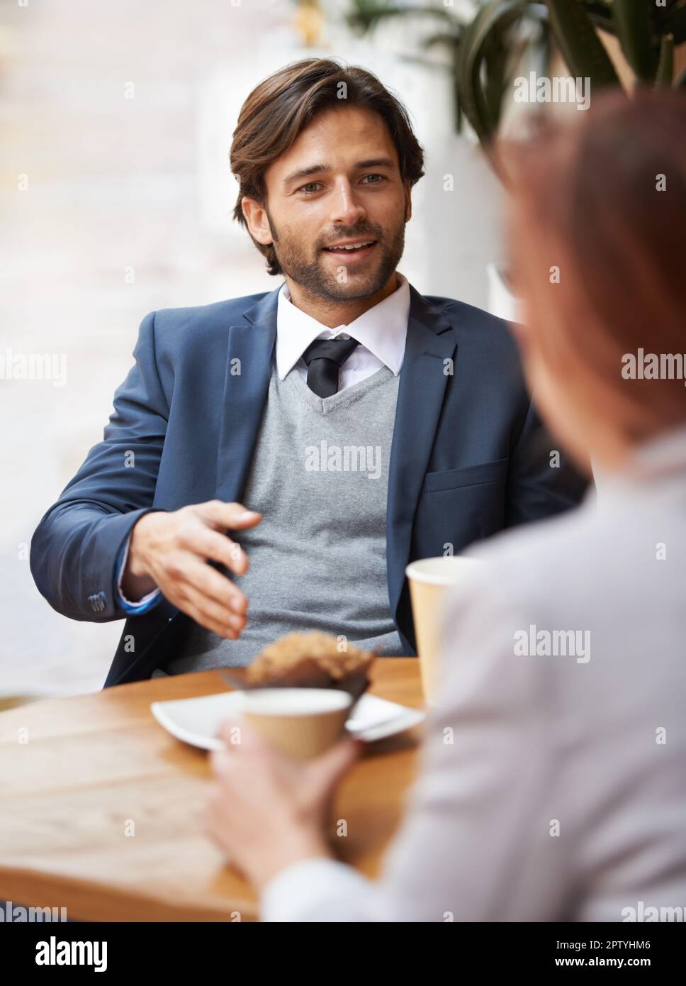 Coffee shop business discussions. A businessman and woman having a ...