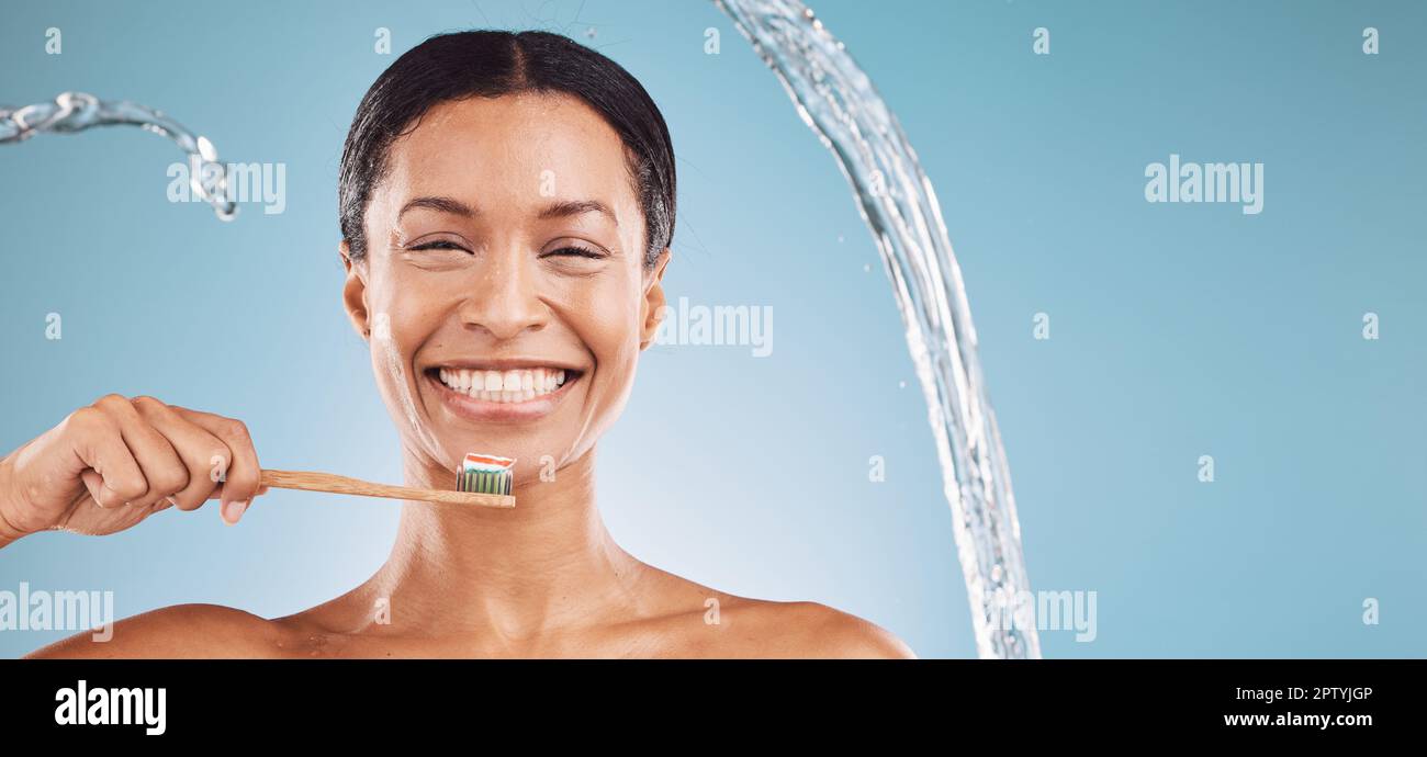 Black woman, toothbrush and brushing teeth with a water splash and ...