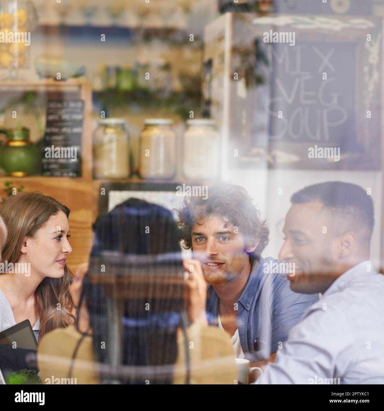 Catching up with old friends. a group of friends talking in a cafe ...