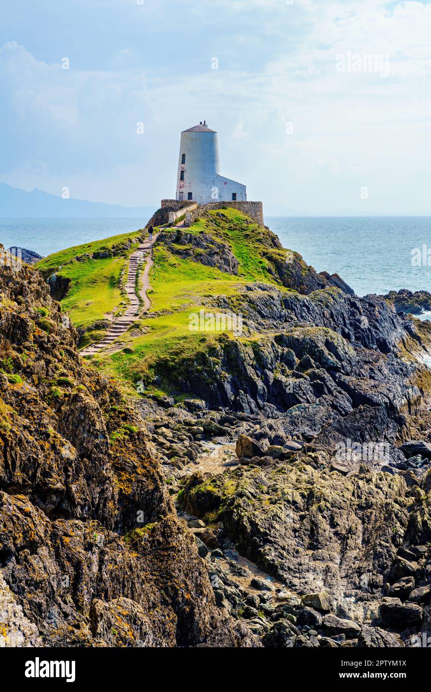 The famous 1838 Llanddwyn Island lighthouse stands proudly on the rock of Newborough Beach ...
