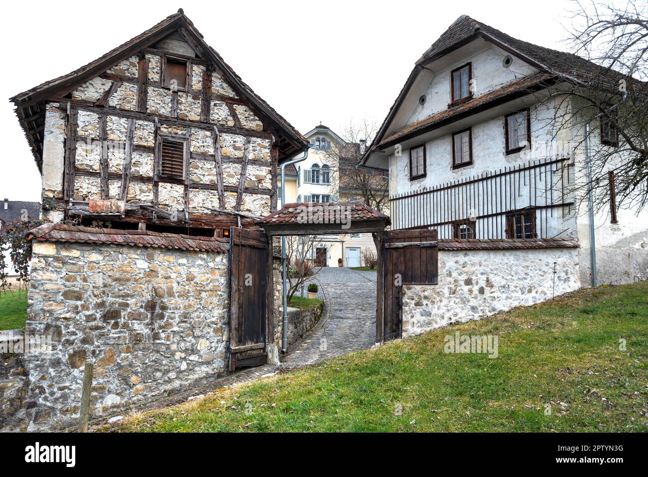 The entrance to an old farm with gate and half-timbered house Stock ...
