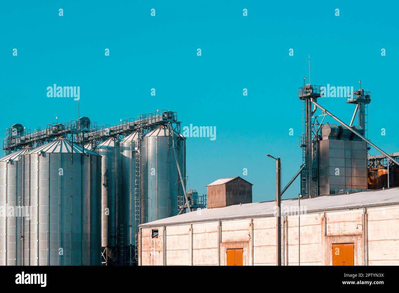 Snowy silos in winter. Industrial elevator dryers, building exterior ...