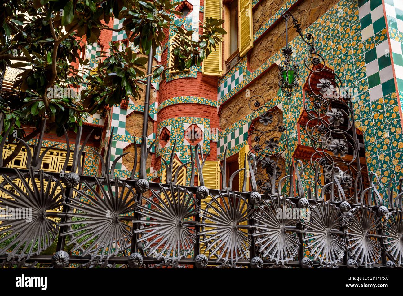 Facade of Casa Vicens and wrought iron fence with Mediterranean dwarf ...